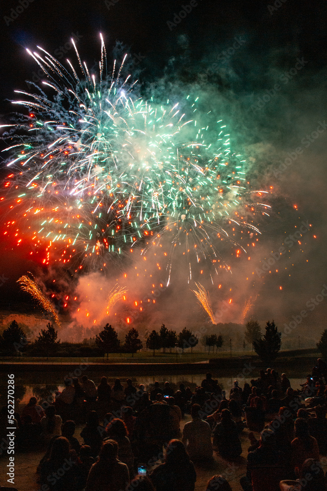 Striking photo of fireworks display in bustling urban park with joyful ...