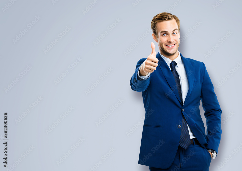 Image of excited businessman showing thumbs up like hand sign gesture ...