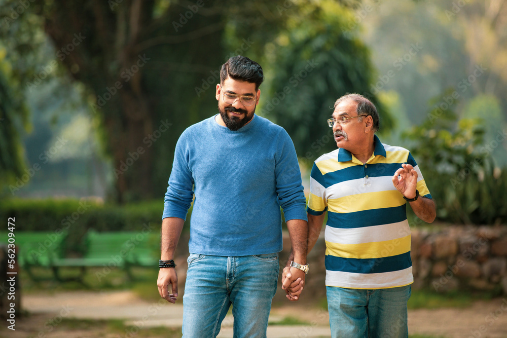 Old indian father talking with his young son at park. Stock Photo ...