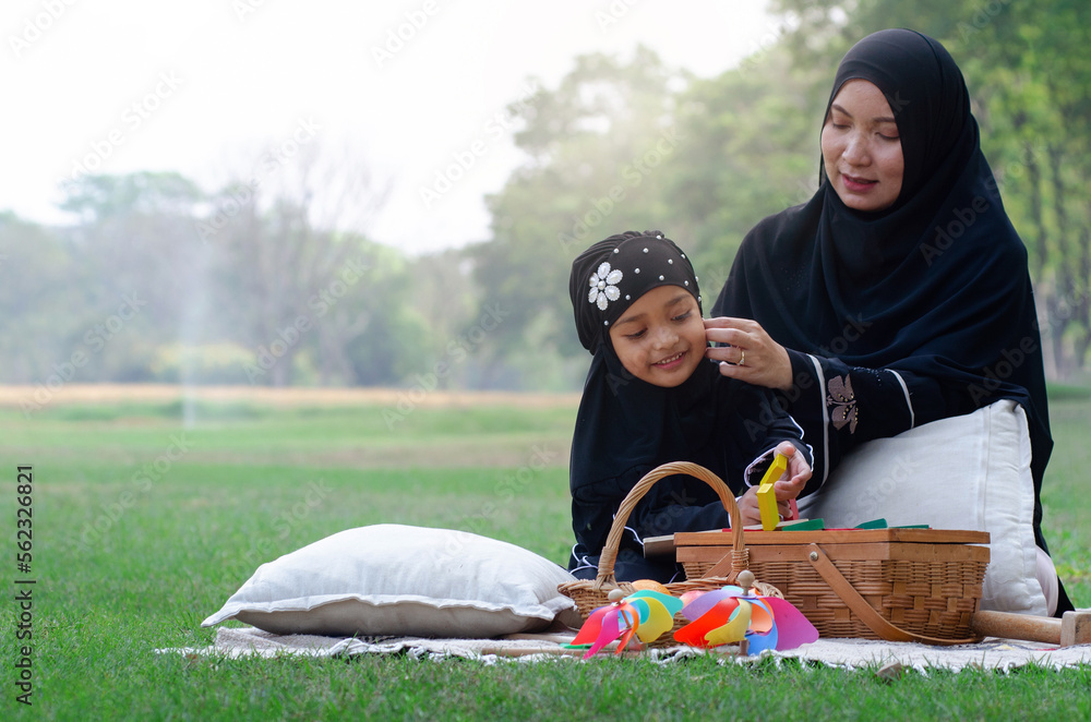 Happy Muslim mother and daughter in black Hijab enjoy spending time ...