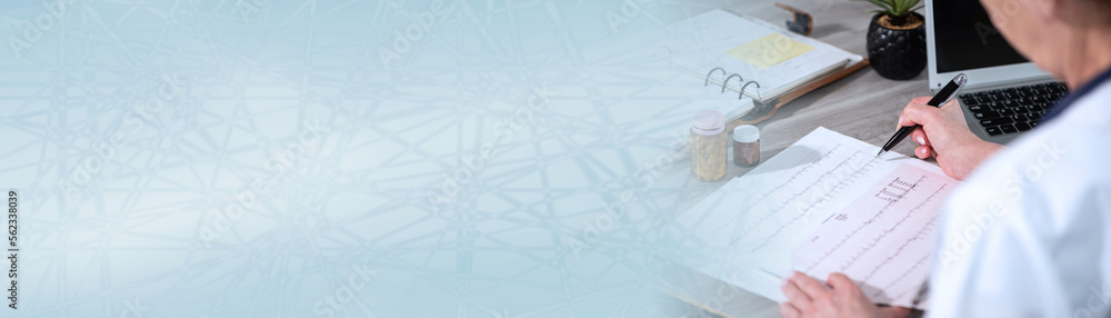 Female cardiologist examining an ecg graph; panoramic banner Stock ...