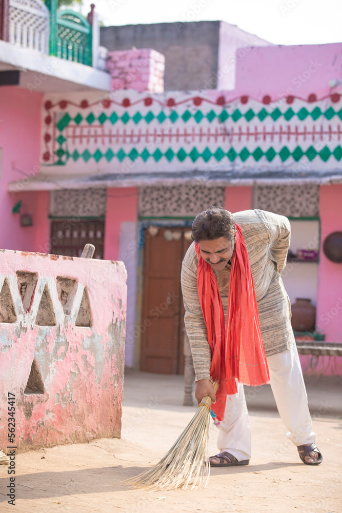 Indian man cleaning house with broom Stock Photo | Adobe Stock