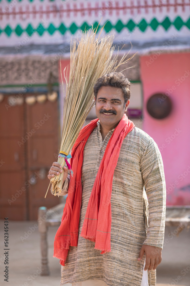Indian man cleaning house with broom Stock Photo | Adobe Stock