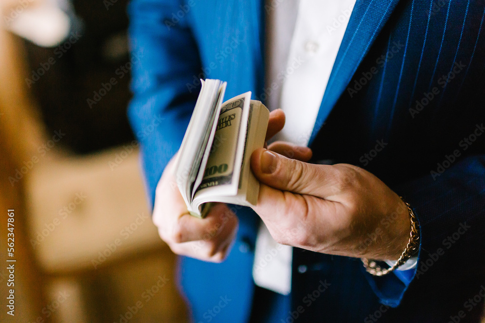 Man in suit showing dollar banknotes. Hands counting money American ...