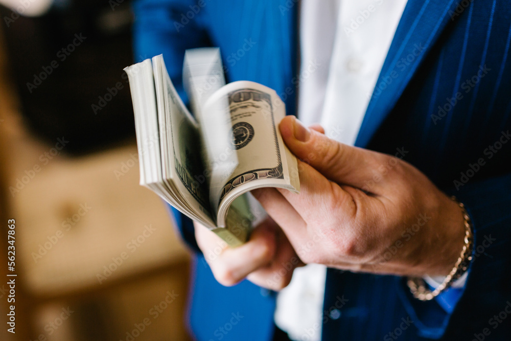 Man in suit showing dollar banknotes. Hands counting money American ...