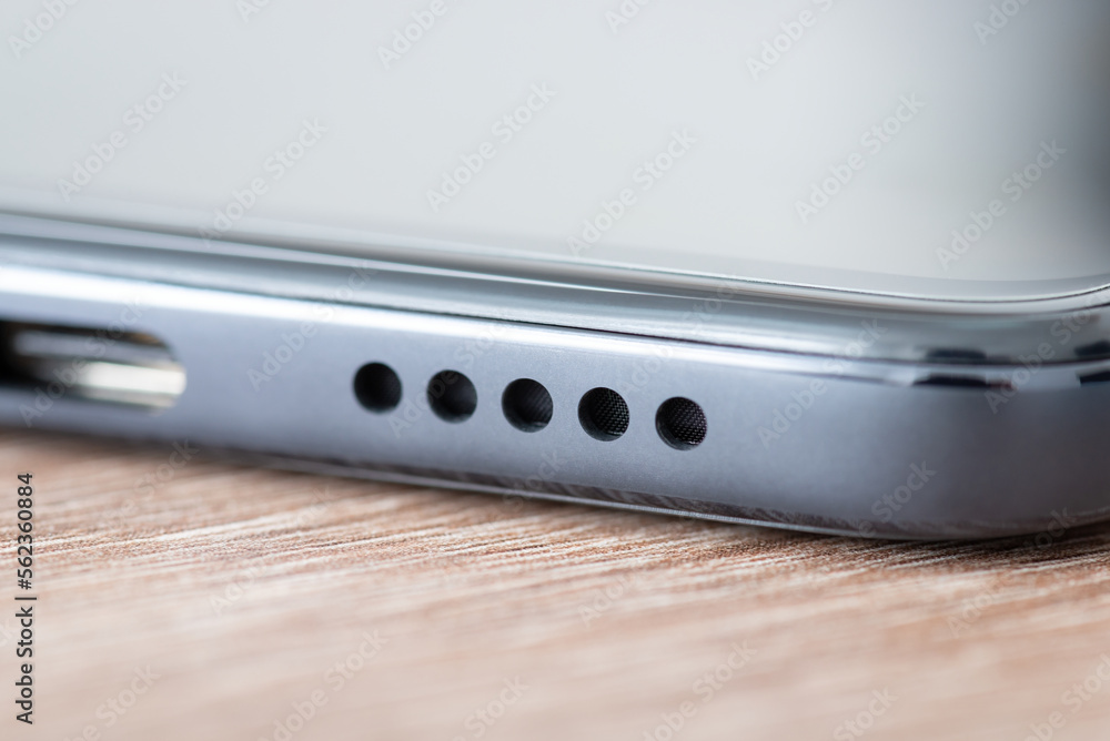 Macro shot of down panel of mobile phone with usb type-c port and ...