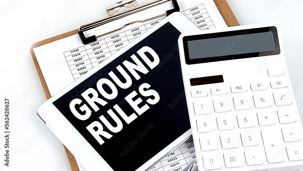 GROUND RULES text on a tablet with chart, calculator and pen Stock ...