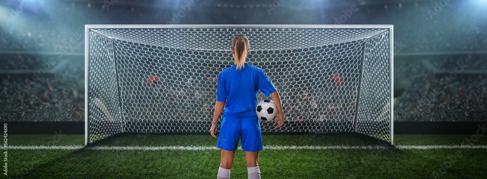 Stadium and goal post and a female soccer player in front of the soccer ...