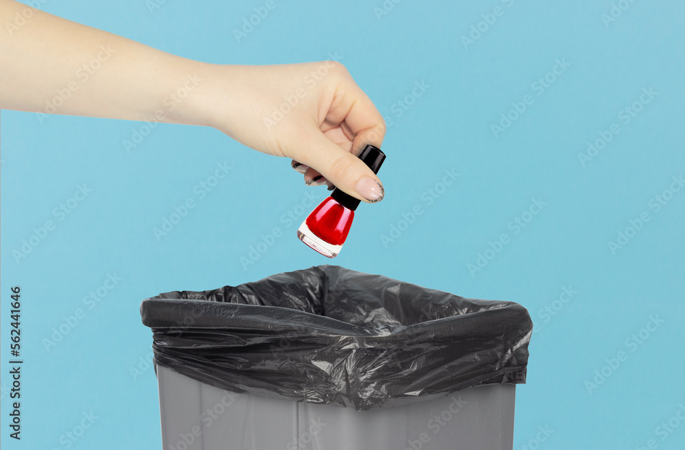 throw away the polish in the trash can, nail polish in the hands in ...