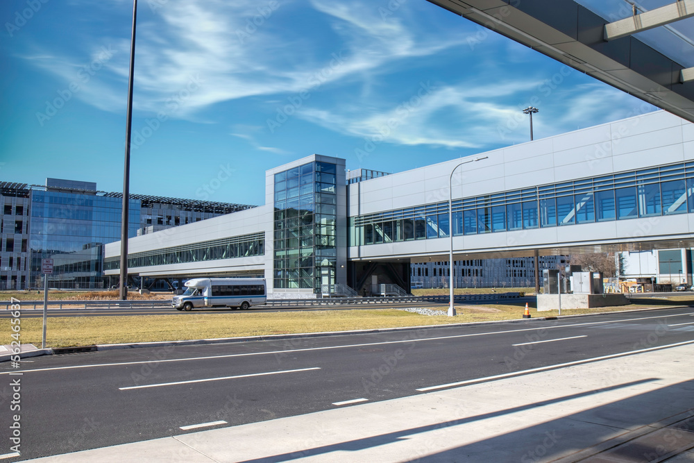 Exterior daytime view of a pedestrian bridge crossing four lanes of ...