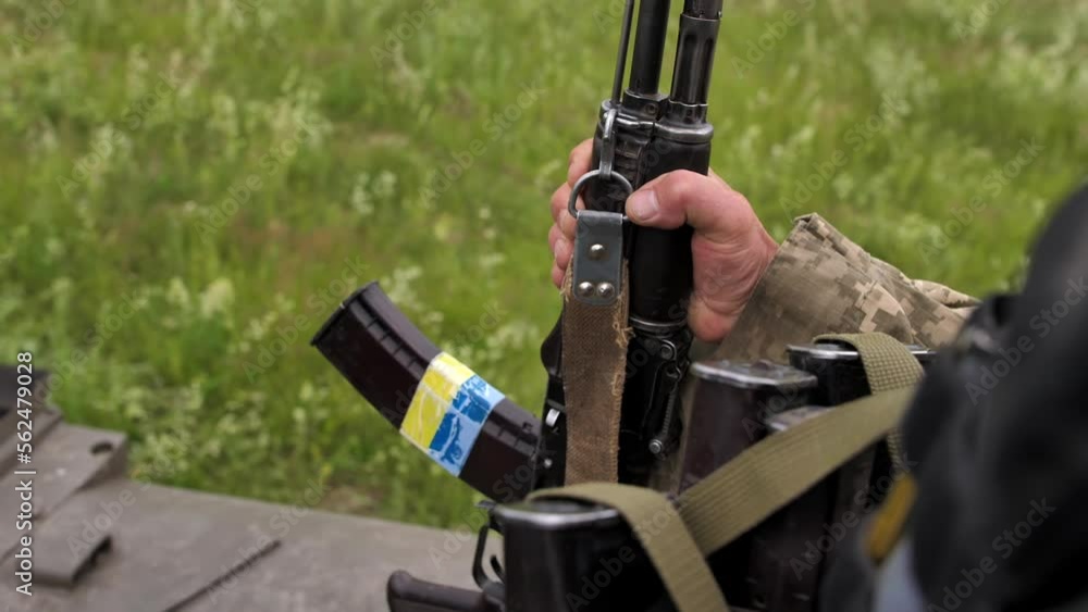 Soldier of the Armed Forces of Ukraine rides on top of an armored ...