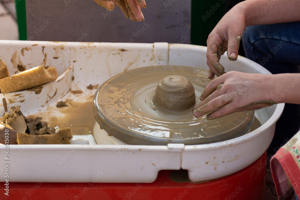 Making A Clay Pot. Potter working on potters wheel making ceramic pot ...