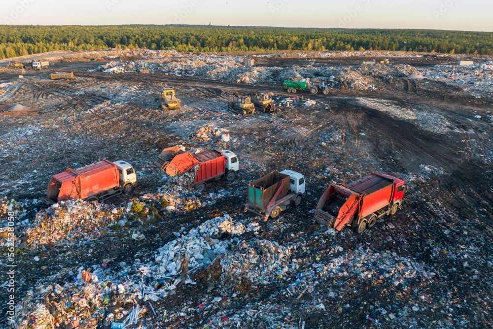 Garbage truck unloads rubbish in landfill. Landfill waste disposal ...