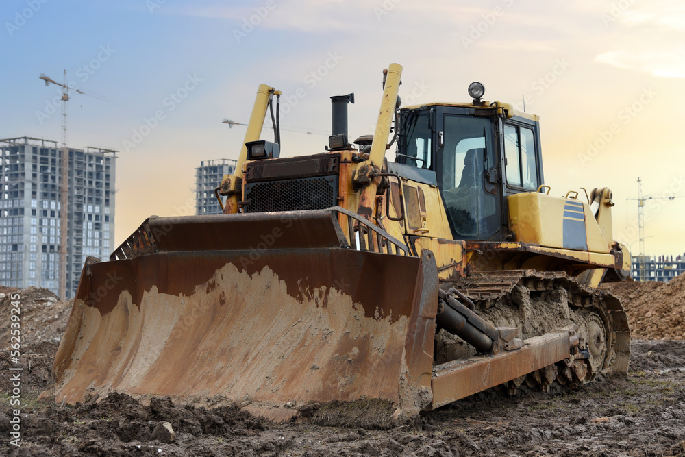 Dozer at construction site, utility trenching. Earth-moving equipment ...