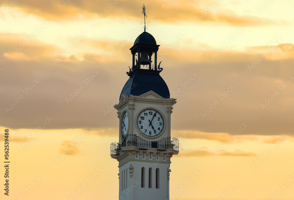 Clock tower building on sunset. Large clock tower with hour hands that ...