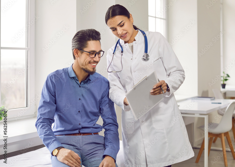 Professional female doctor smiles and shows positive examination ...