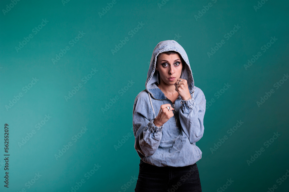 Aggressive woman clenching fists and showing raised knuckles on camera ...
