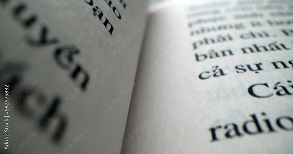 Macro view open book with white pages against black background. Dolly ...