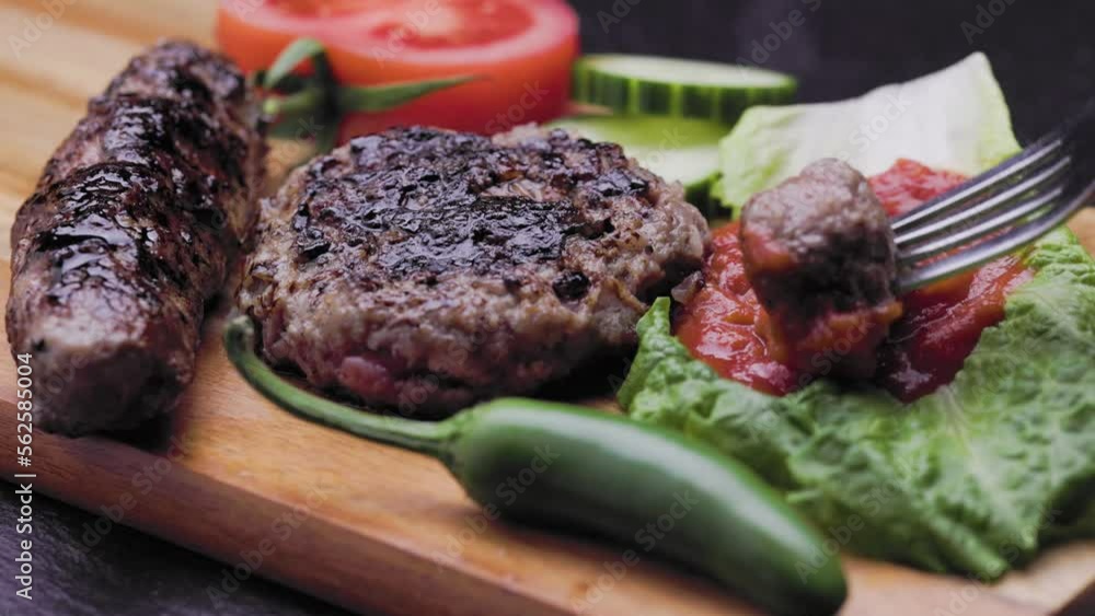 Dipping a piece of Bulgarian skinless sausage kebapche into traditional ...