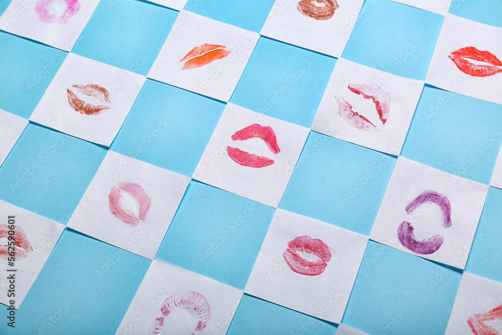 Paper sheets with lipstick kiss marks on blue background Stock Photo ...