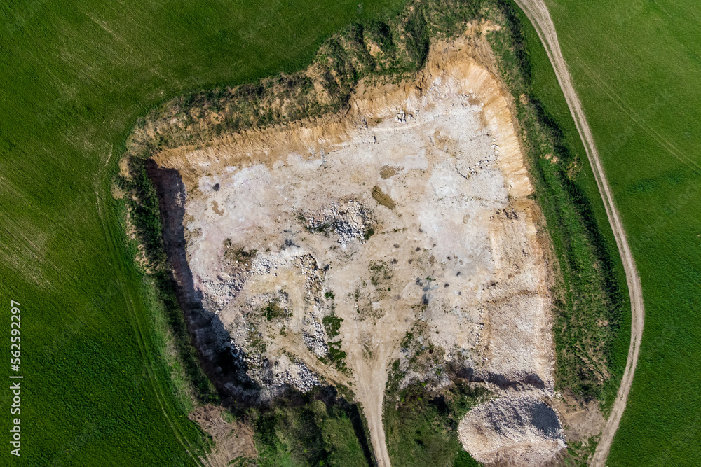 View from a high altitude of a stone quarry dug in the middle of a ...