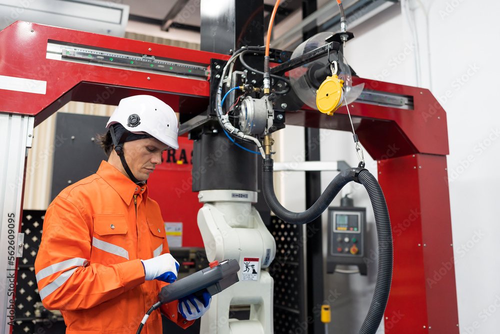 Male engineer repair or maintenance automatic robot arm system in the ...