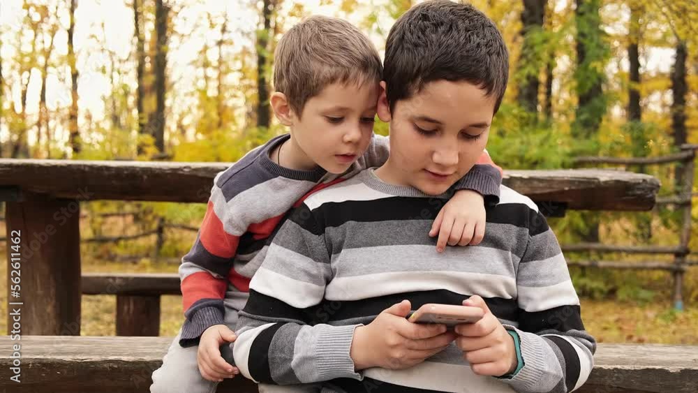 Kids playing with modern mobile devices. Children sitting with smart ...