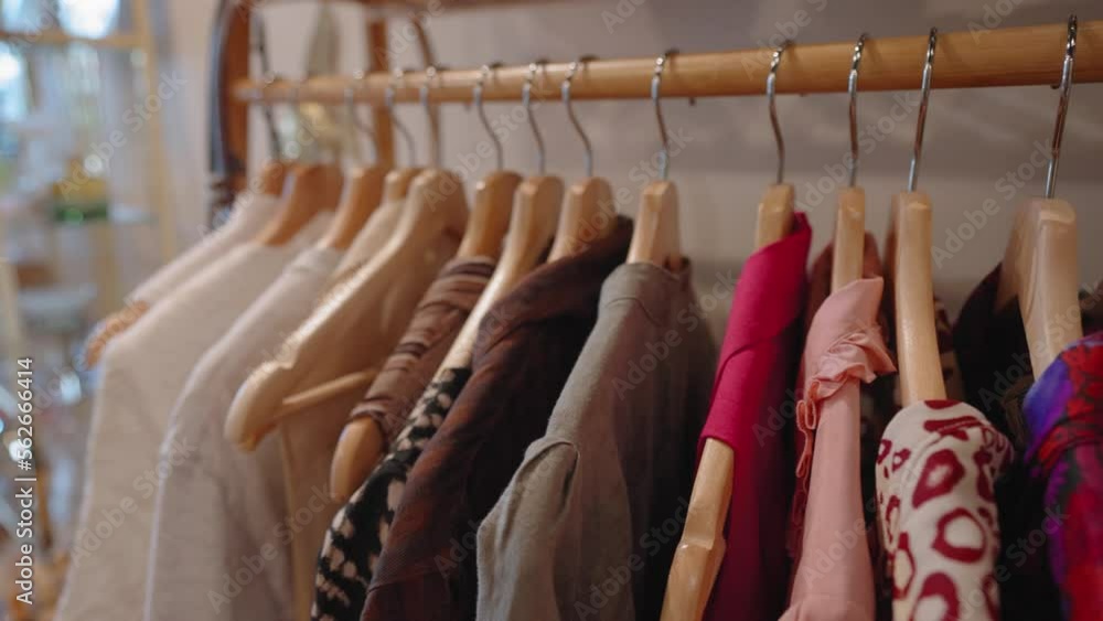 Clothes on a clothing rack at a thrift store. Second hand clothes for ...