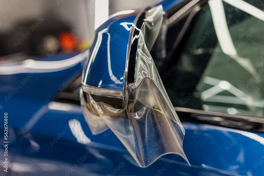 The process of installing PPF on the side mirror. PPF is a protective ...