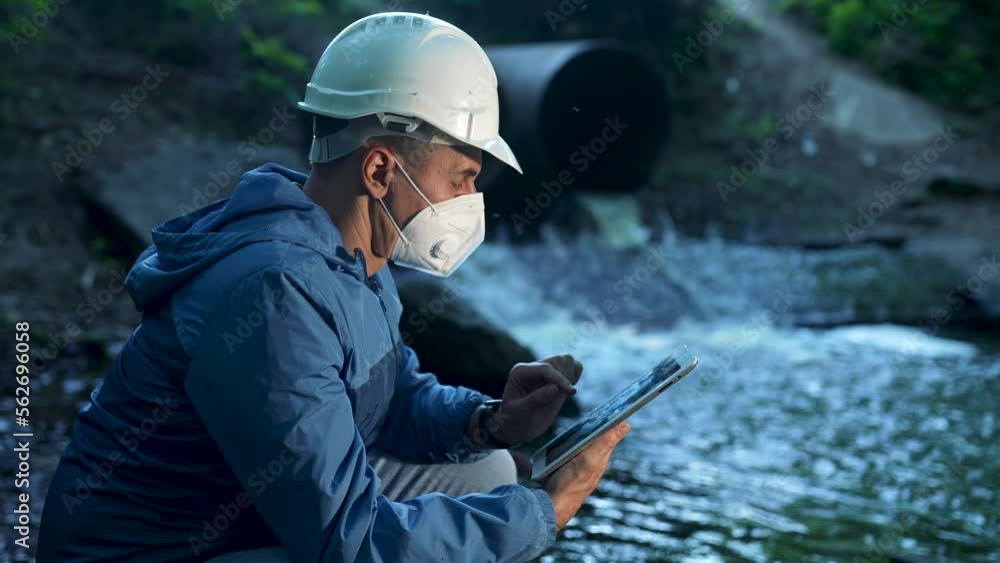 Engineer worker checking water quality of river. Wastewater treatment ...
