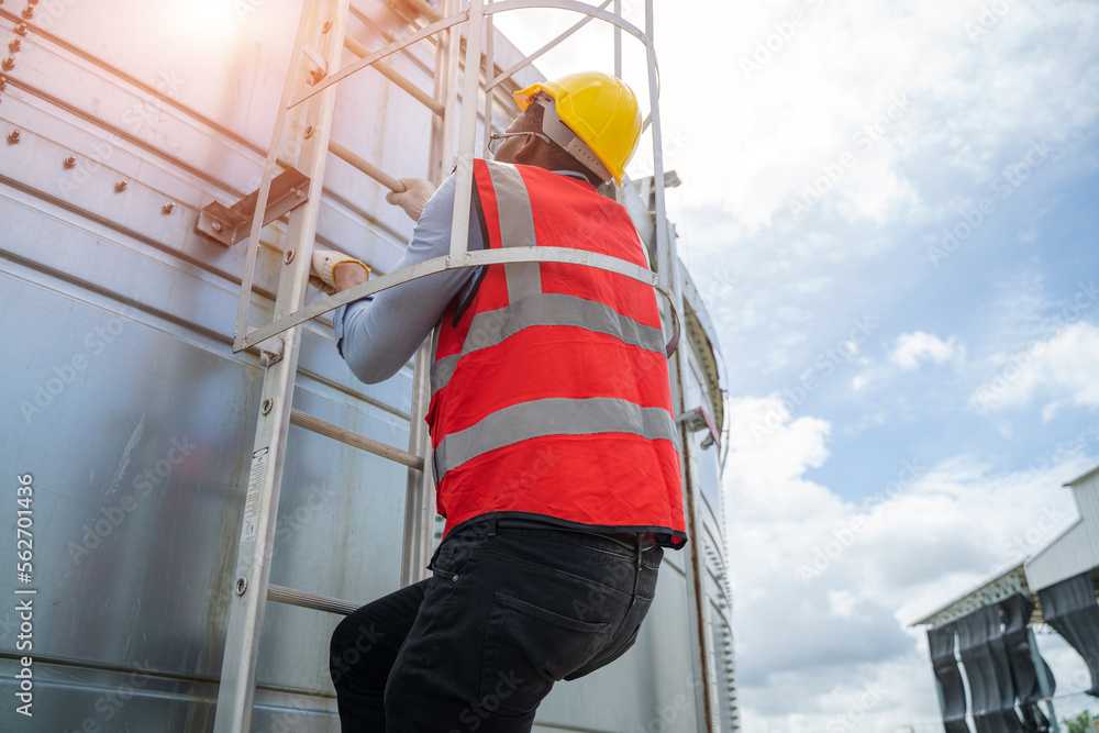 Construction worker wearing safety harness and safety line working at ...