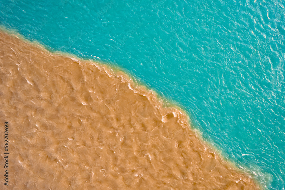 Water pollution by waste from factories and production. Confluence of ...