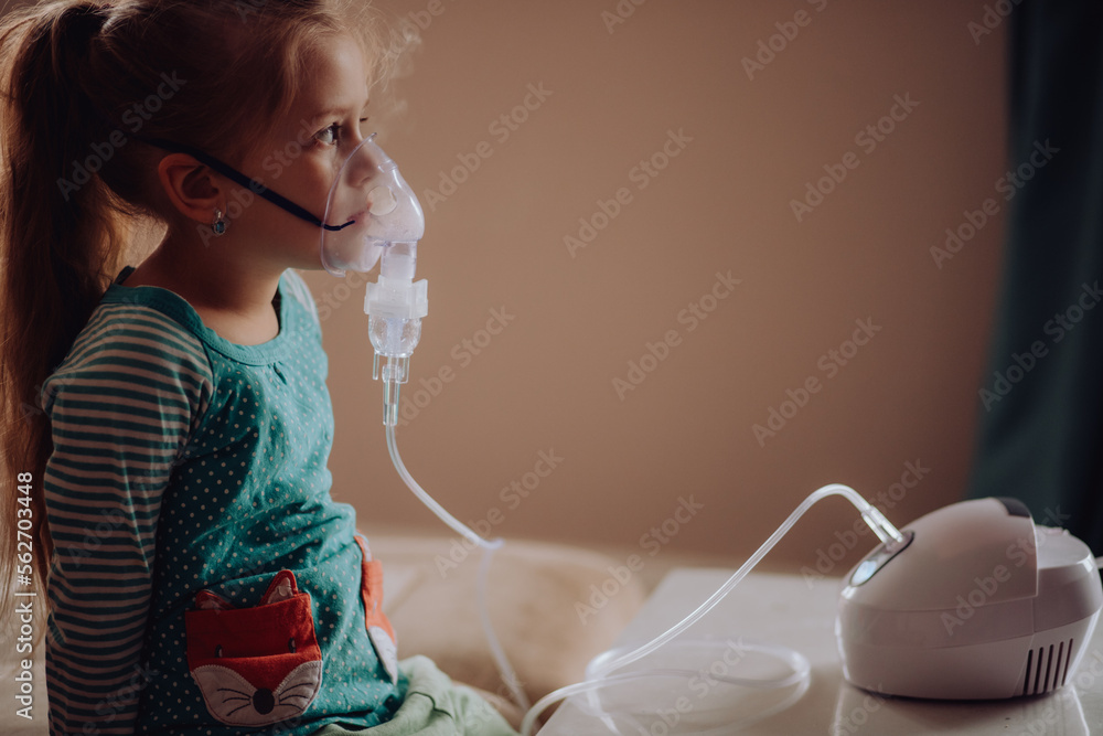 the little girl is sick. the child breathes with an inhaler at home ...