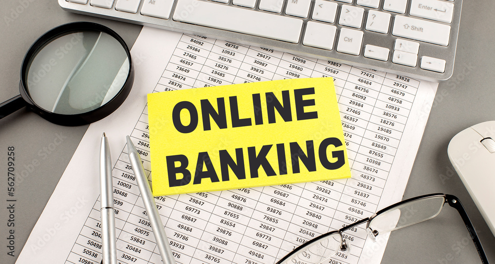 ONLINE BANKING text written on a sticky on chart with keyboard and ...