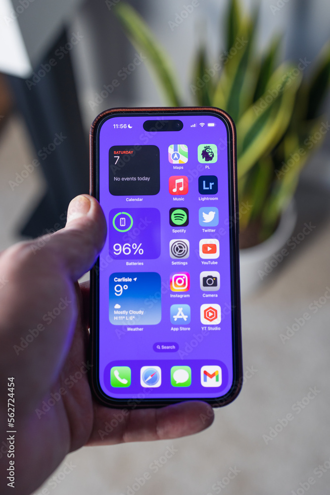 LONDON - JANUARY 07, 2023: Man holding Apple iPhone 14 Pro in hand with ...