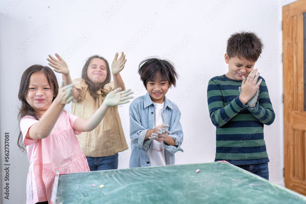 Children in class room happy laughing enjoy chalk drawing on green ...