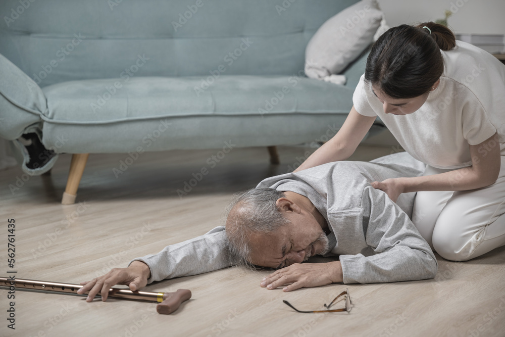 Asia young woman halping her father after falling down on floor ...