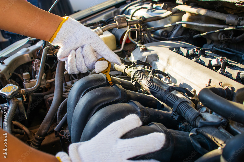Male mechanic using inspection tool for maintenance repair car engine ...