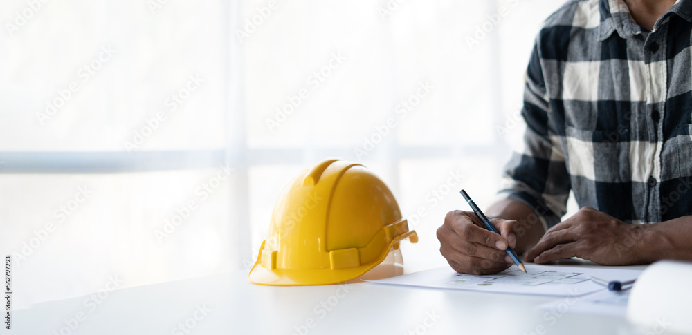 Engineer drawing a blue print design building or house, An engineer ...