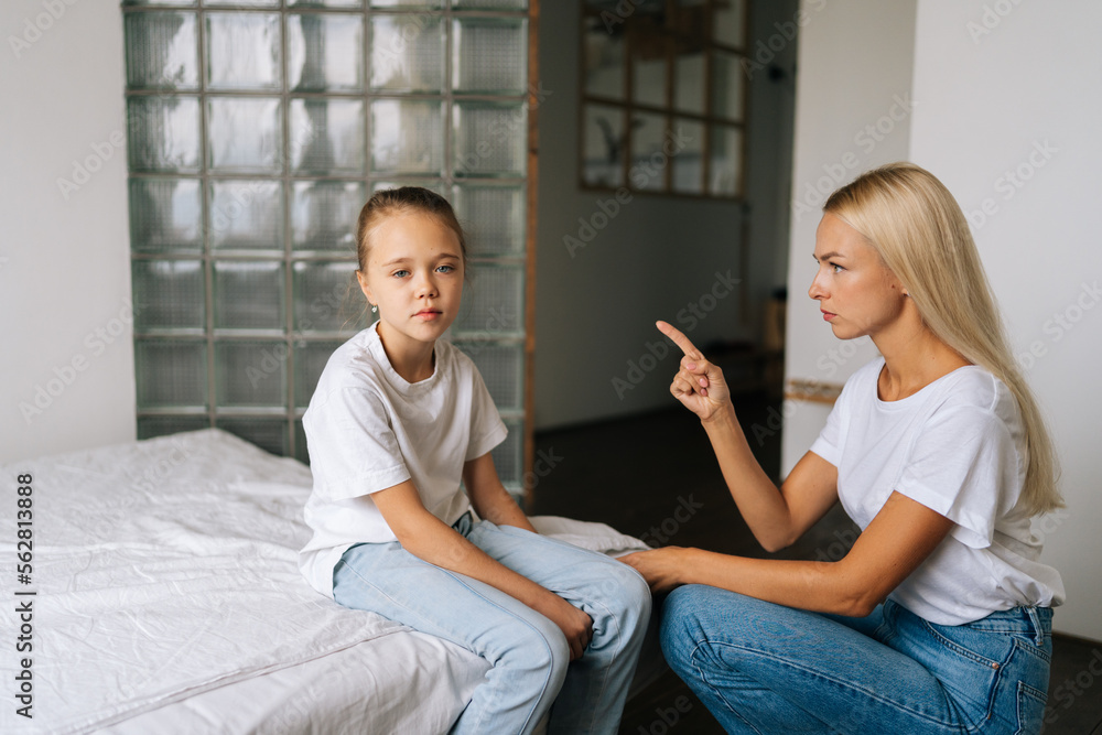 Aggressive young mom scolding, raising voice, scream and pointing ...