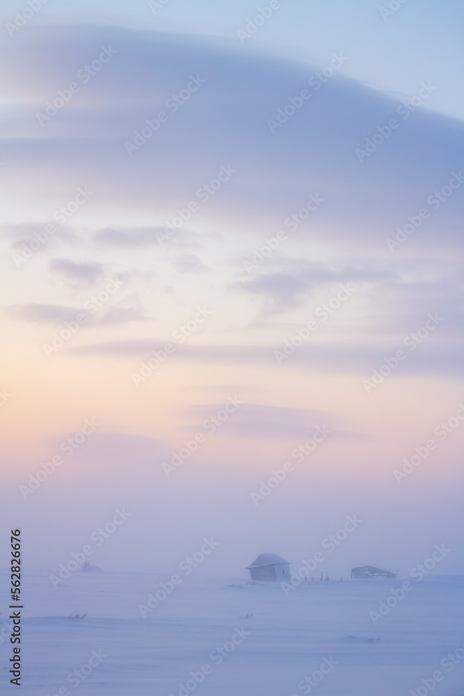 Winter arctic landscape. View of a small house in the snowy tundra. Low ...