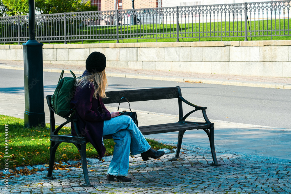 Person Waiting On A Bench