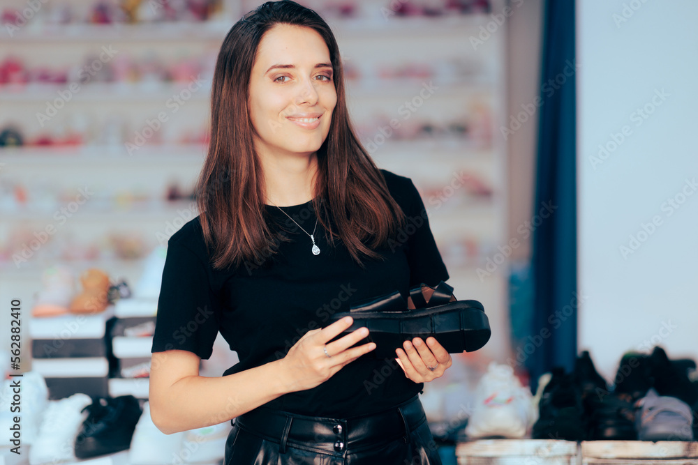 Happy Shopping Assistant Arranging Sandals in Store. Customer looking ...
