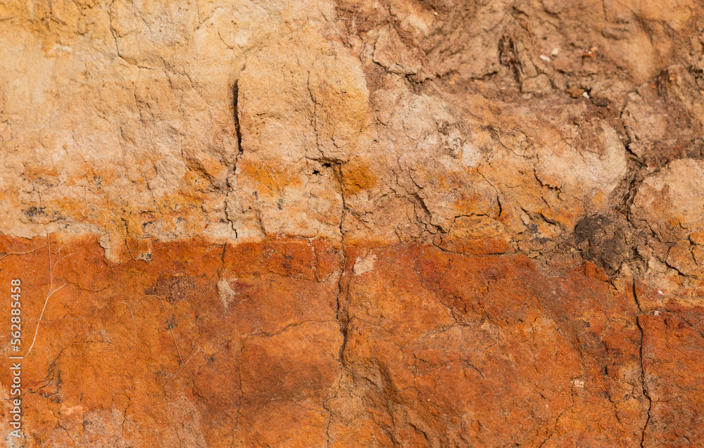 Sedimentary rocks with a high content of iron oxide. Red soil, loam ...