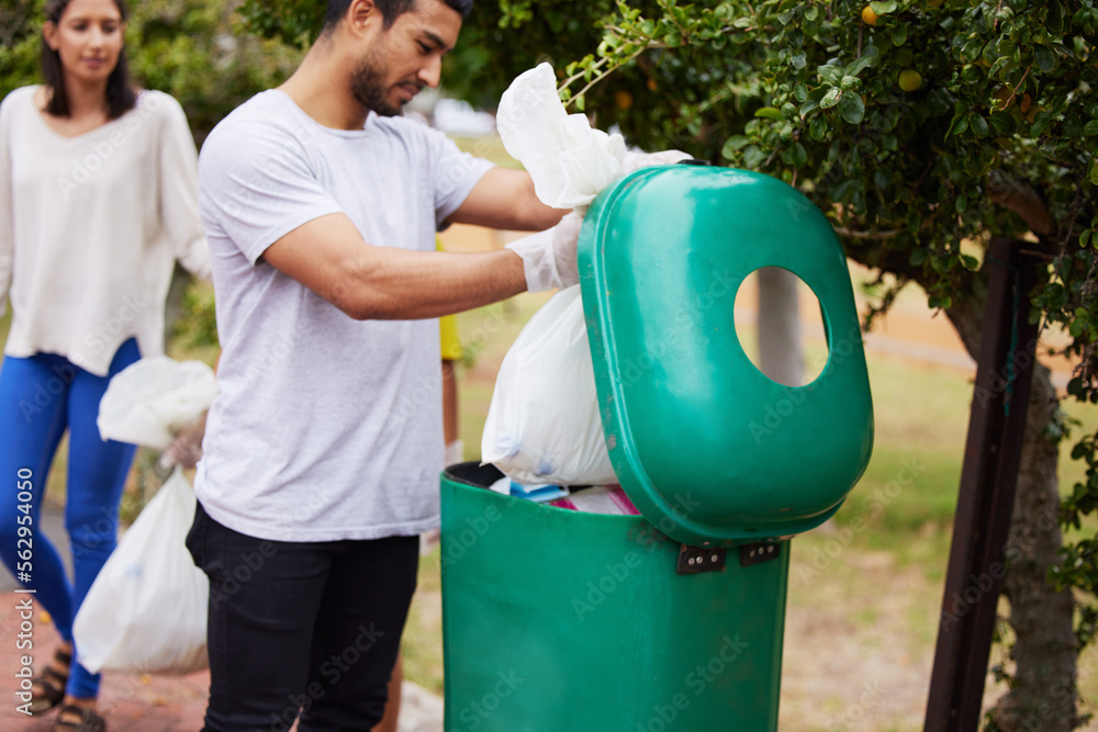 Volunteer cleaning, garbage bin and man throw trash, pollution or waste ...