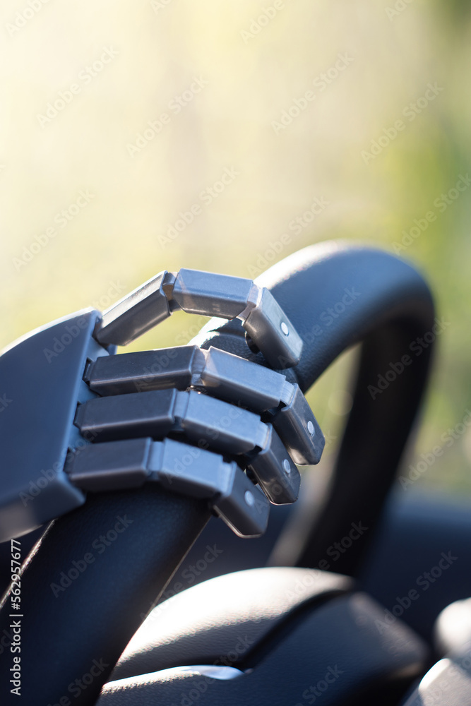 Robot arm on a steering wheel. Artificial intelligence drives a car ...
