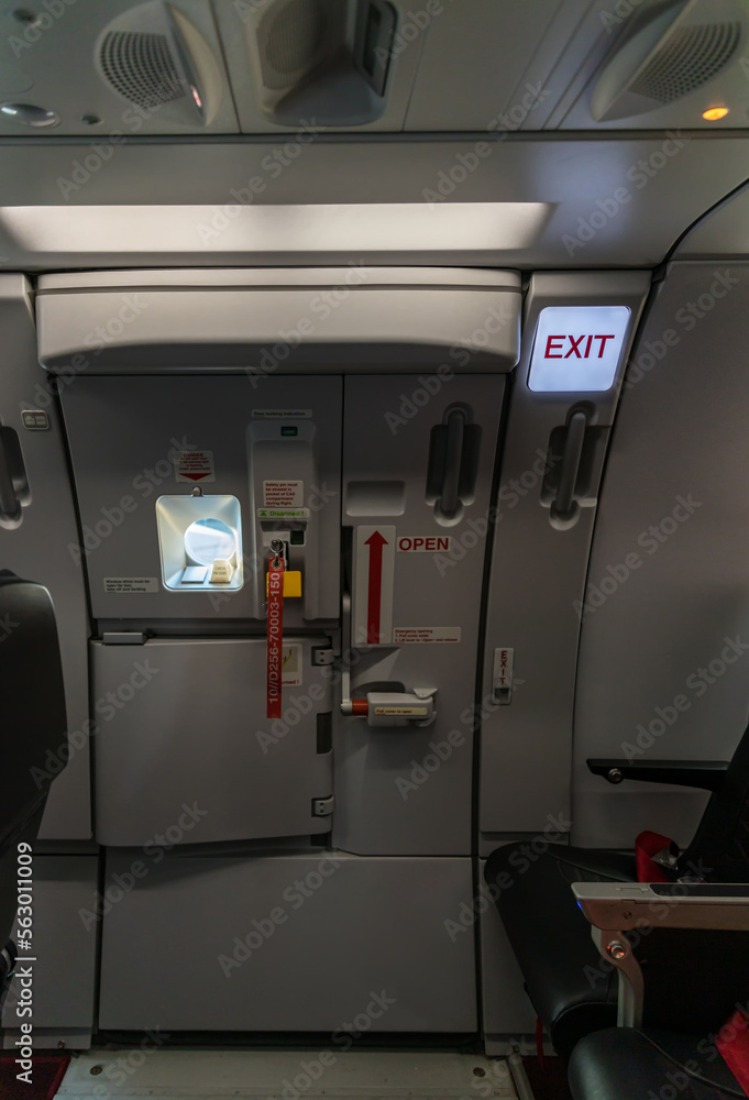 Exit sign in passenger airplane. Emergency exit sign on airplane. Exit ...