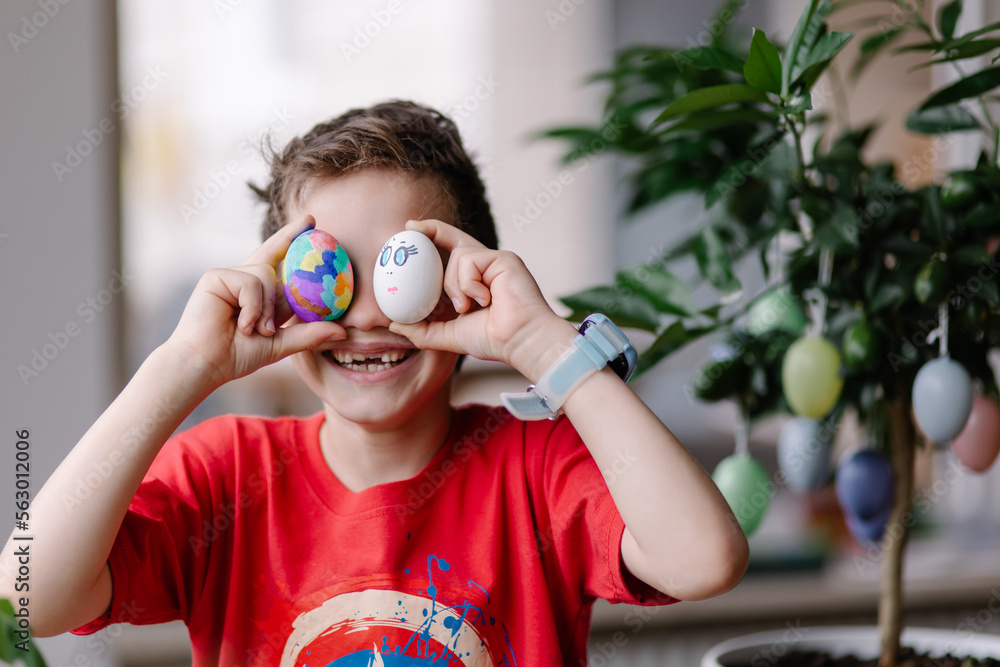 Cheerful boy holding painted eggs and smiling. Sincere children's ...