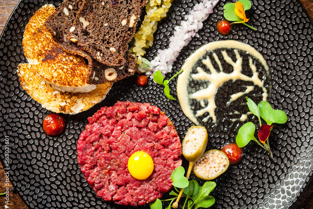 Beef tartare from Black Angus. Onion, quail egg, tomato sauce, mustard ...