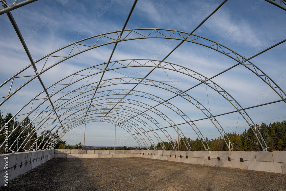 Inside of a large industrial dome in construction. Steel frame. Trusses ...